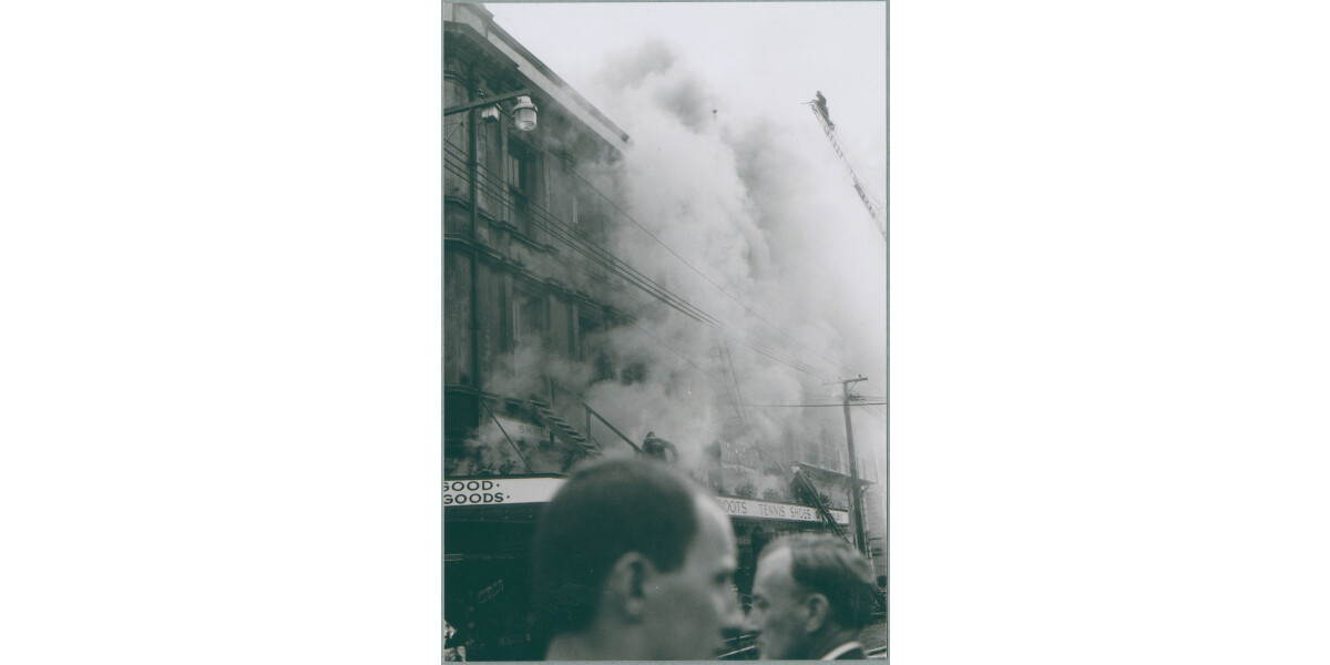 A firefighter on a ladder at the Para Rubber fire | discoverywall.nz