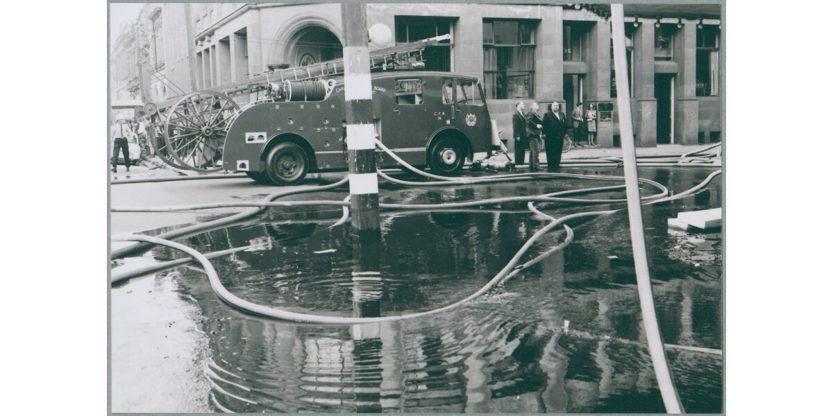 View of a fire truck and a spaghetti junction of hoses