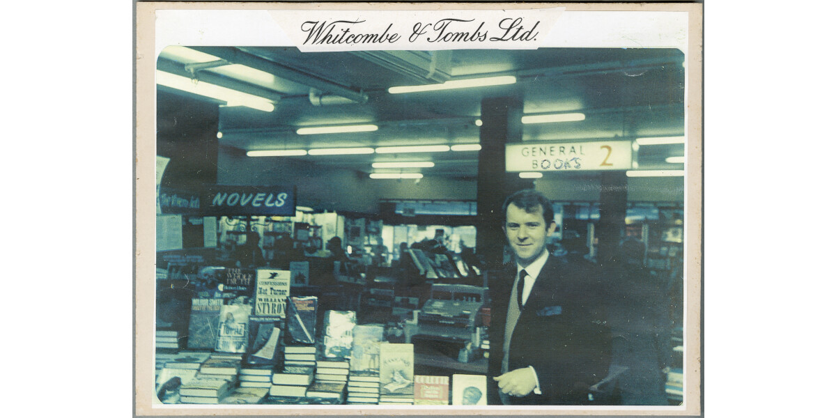 Peter Stuart standing in Whitcombe & Tombs book store