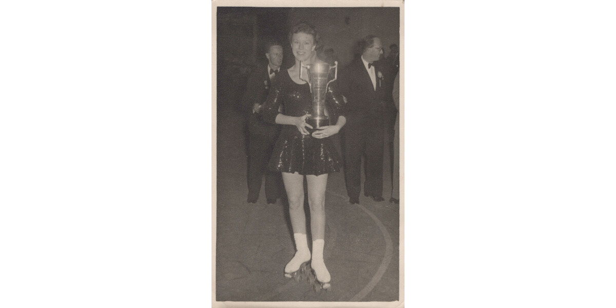 Portrait view of Judy Clancy holding a trophy | discoverywall.nz