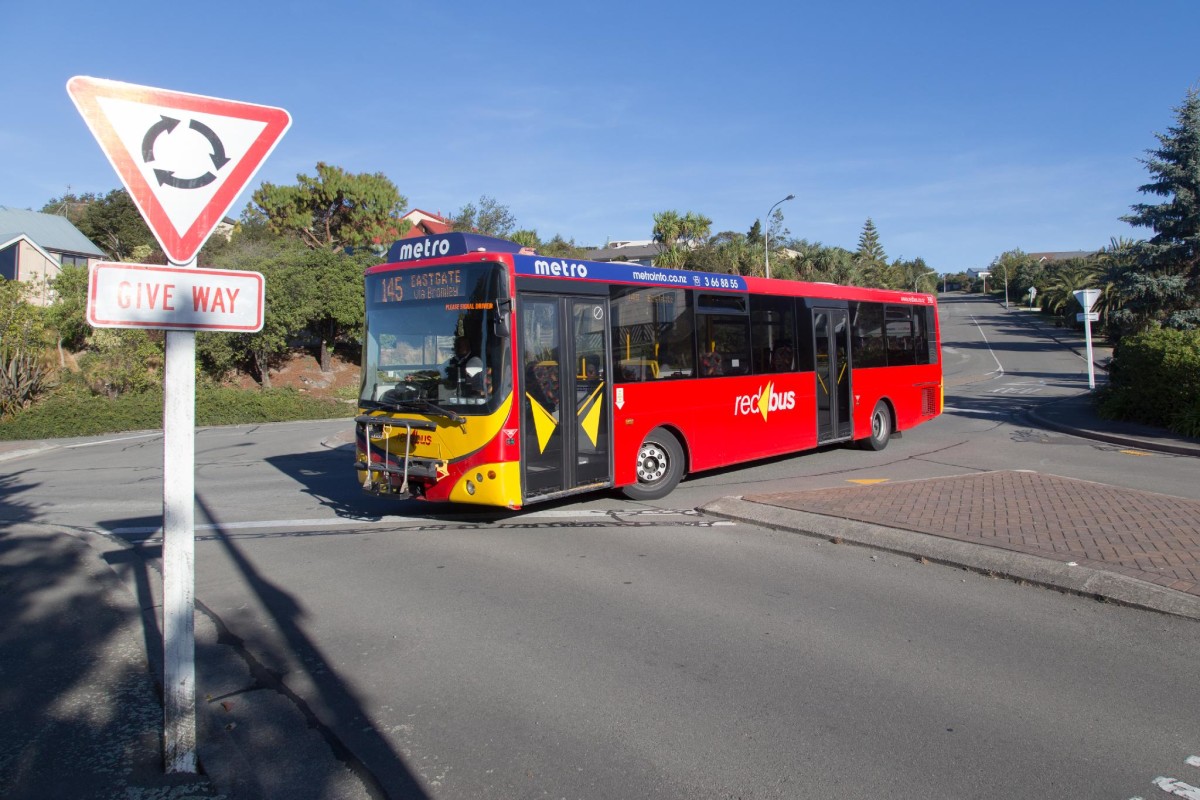 Red bus driving through Westmorland | discoverywall.nz